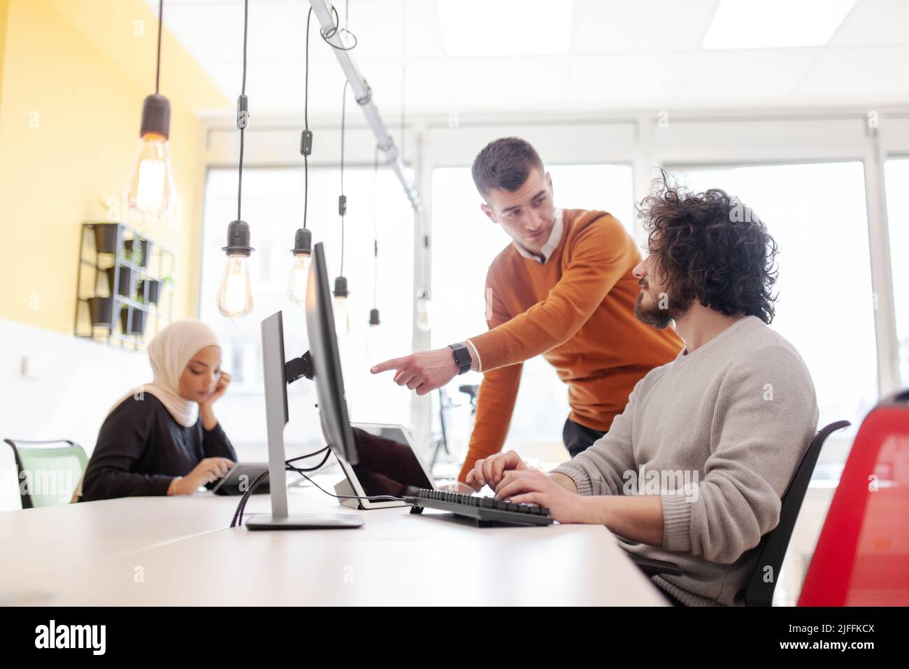Business people having conversation in front of a computer. Modern ...