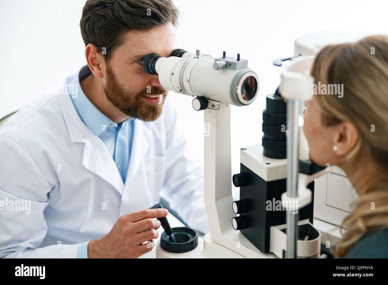 Close-up view of a optometrist checks patient's vision in an optics ...