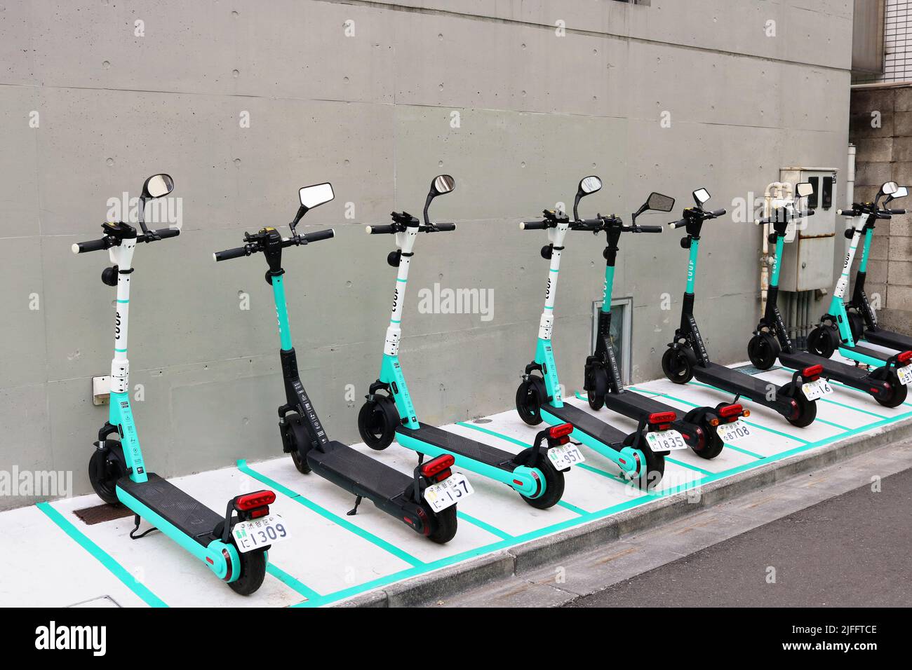 TOKYO, JAPAN - March 24th, 2022: Row of Luup rental e-scooters parked ...