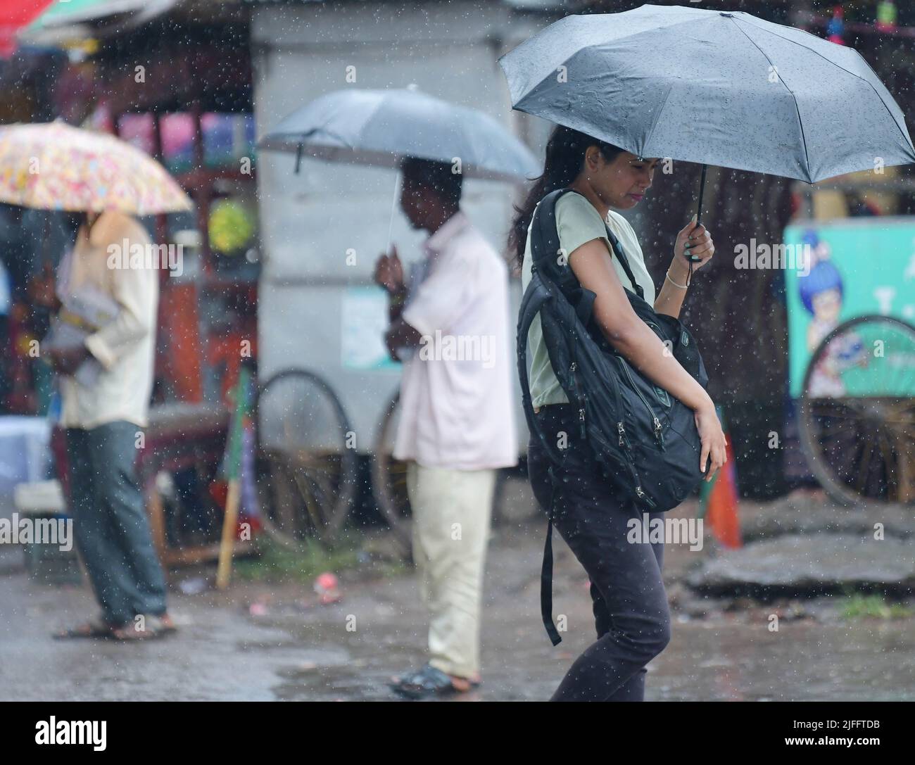Commuters walk during heavy rains in Agartala. Tripura, India Stock ...