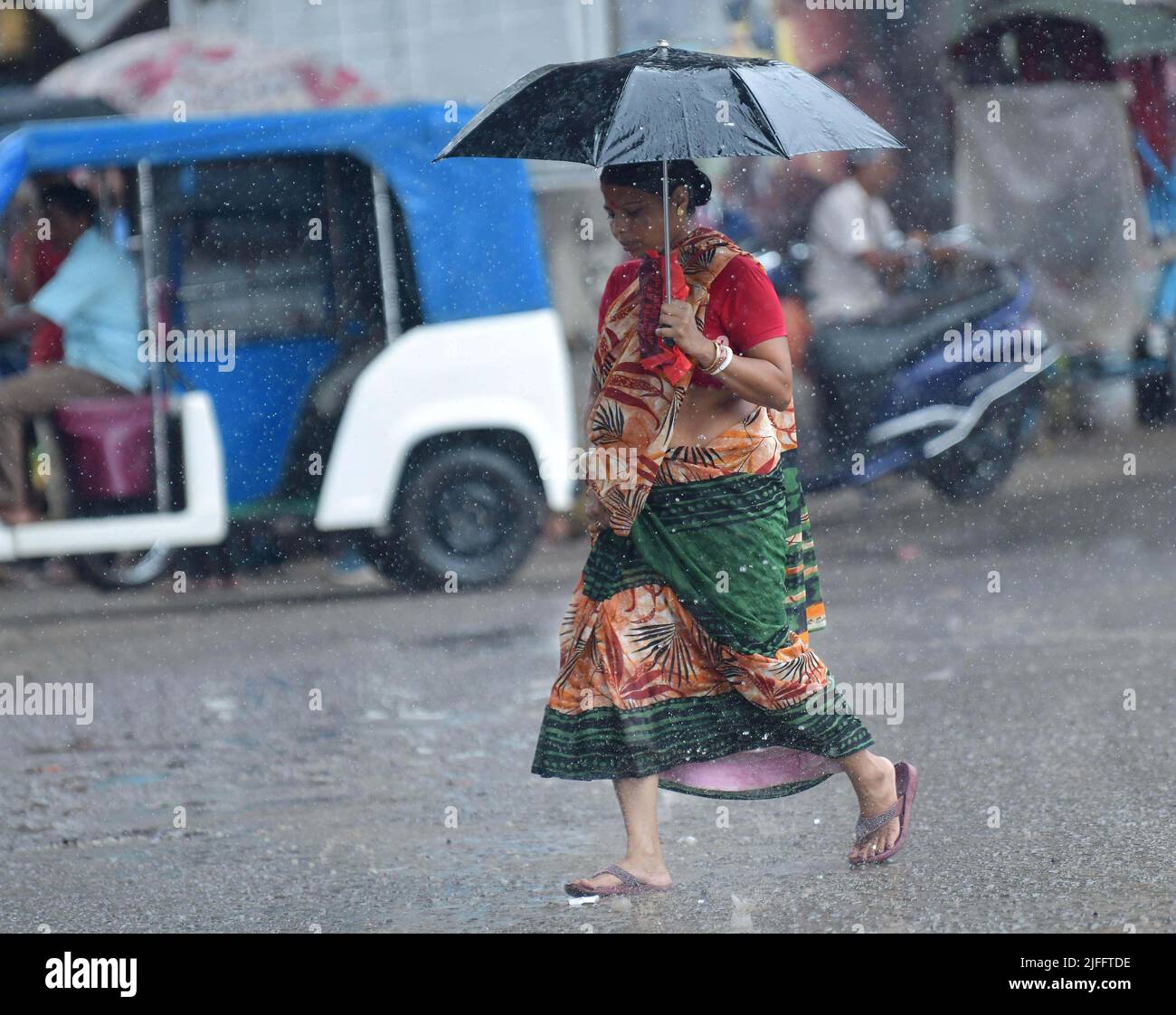Commuters walk during heavy rains in Agartala. Tripura, India Stock ...