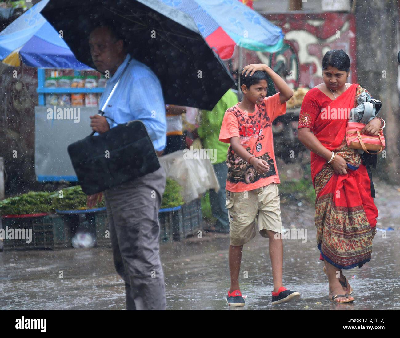 Commuters walk during heavy rains in Agartala. Tripura, India Stock ...