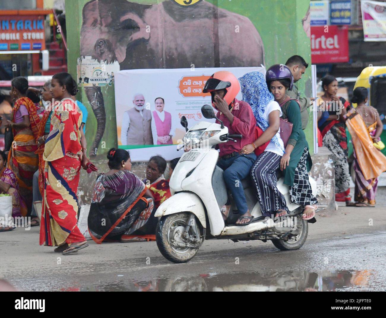 Commuters traveling by bike during heavy rain in Agartala. Tripura ...