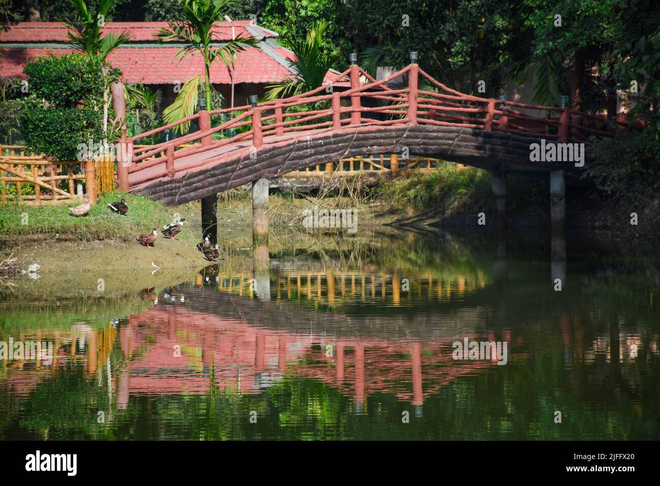Beautiful red arch bridge and clear green lake in Lataguri resort, West ...