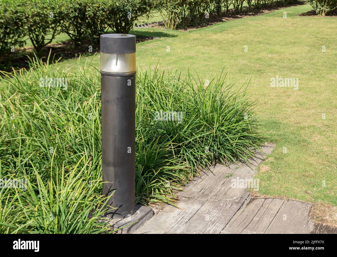 Black metals lamp post in green yard Stock Photo - Alamy