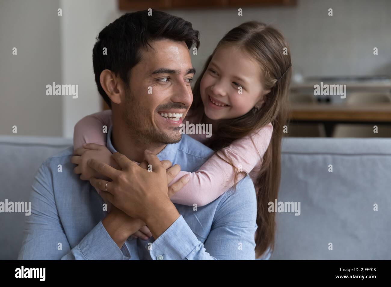 Cute little daughter piggyback loving daddy at home Stock Photo - Alamy
