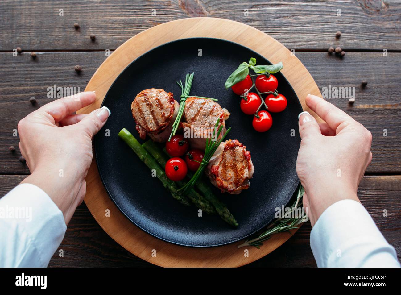 Food serving. Waiter serving a pork dish Stock Photo - Alamy