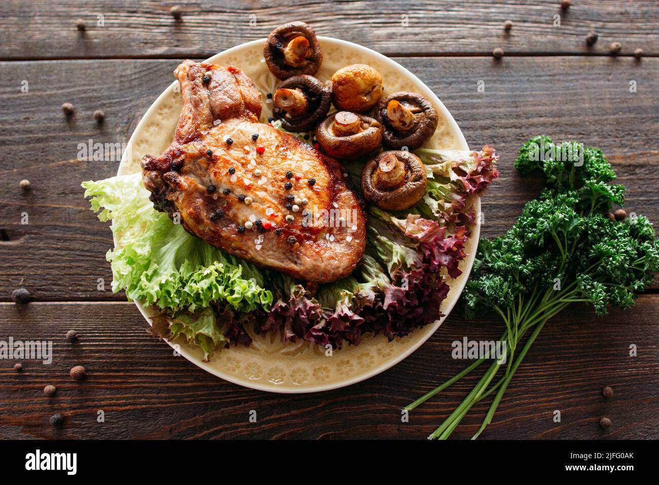 Grilled pork with spicy salad and baked vegetables Stock Photo - Alamy
