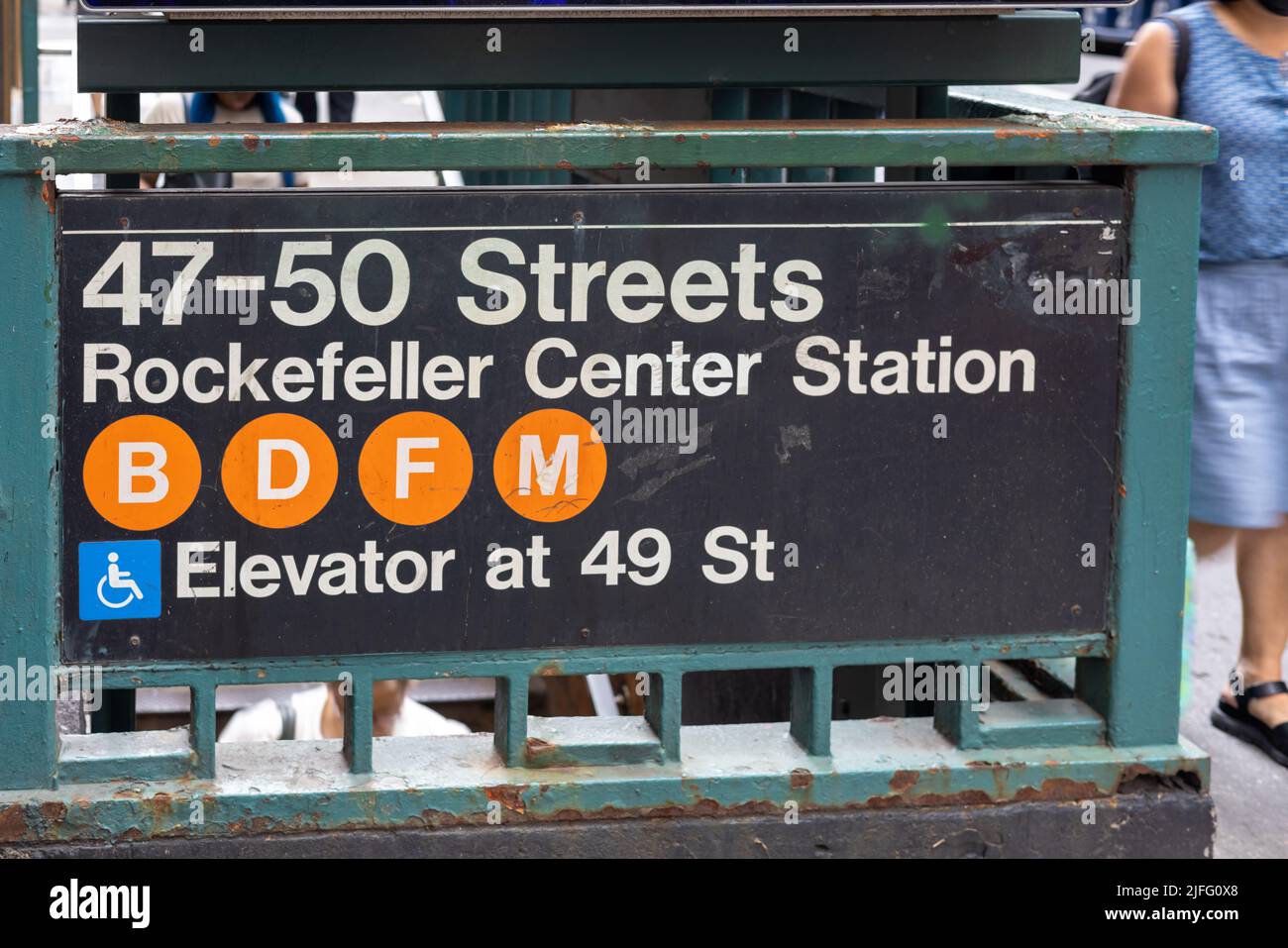 A Rockefeller Center Subway Station sign board on a metal fence at the ...