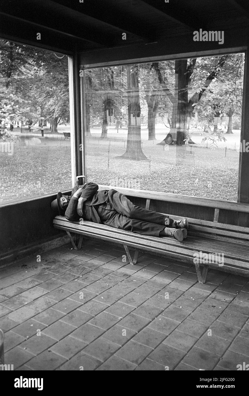 Homeless on bus stop bench hi-res stock photography and images - Alamy