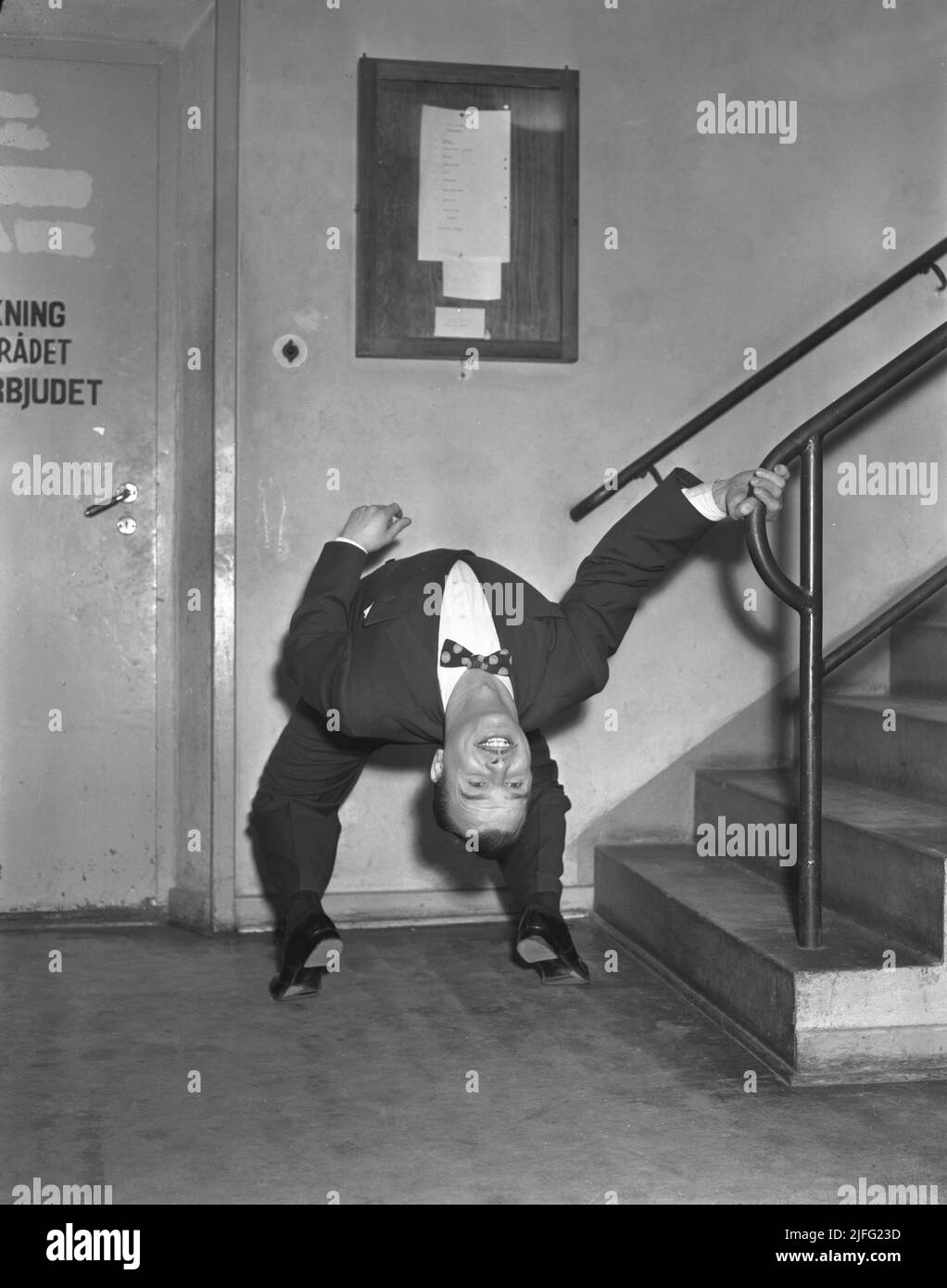 In the 1950s. American actor Dick Remy warming up before going on stage ...