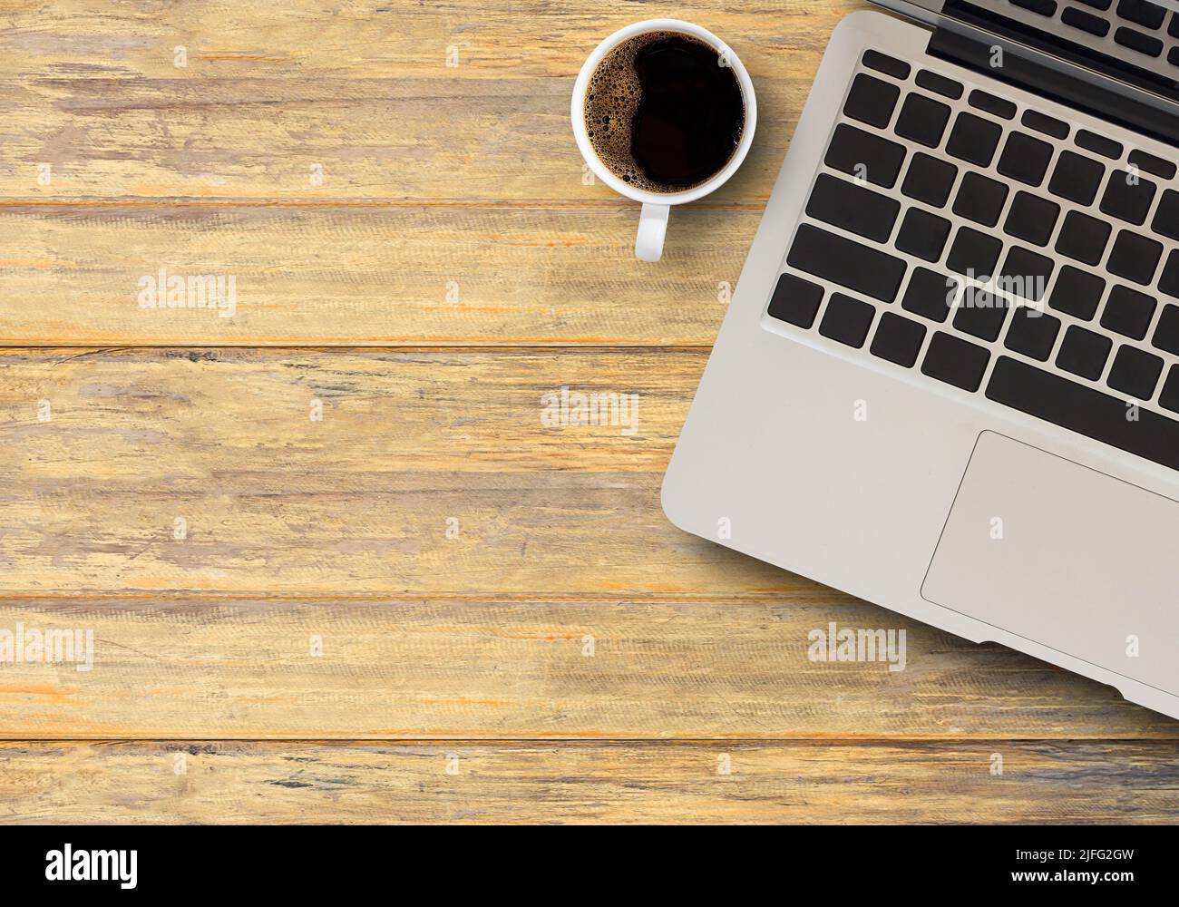 Laptop computer and coffee on the brown wooden desk in office workplace ...
