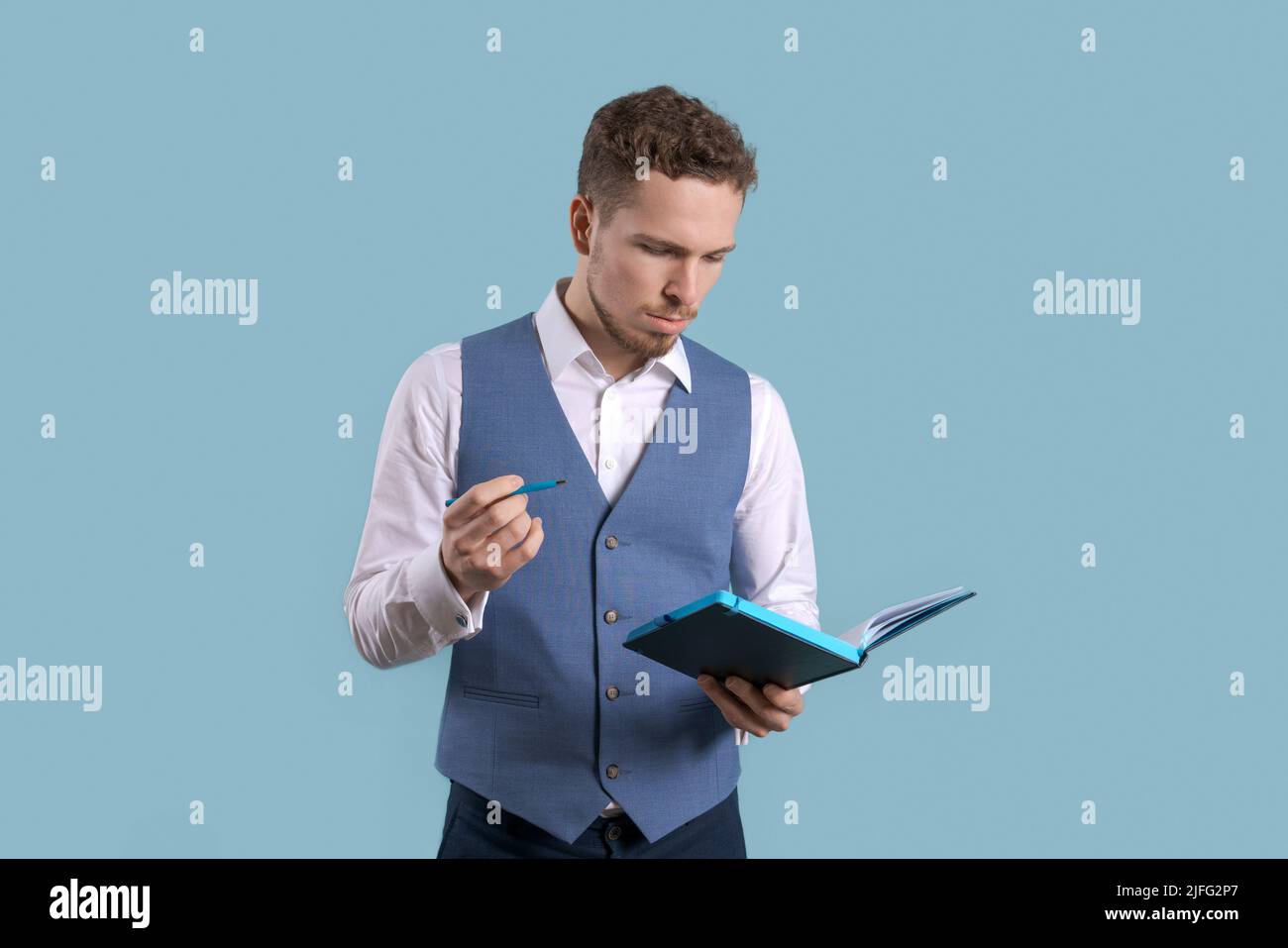 Portrait positive handsome young business assistant with a beard ...
