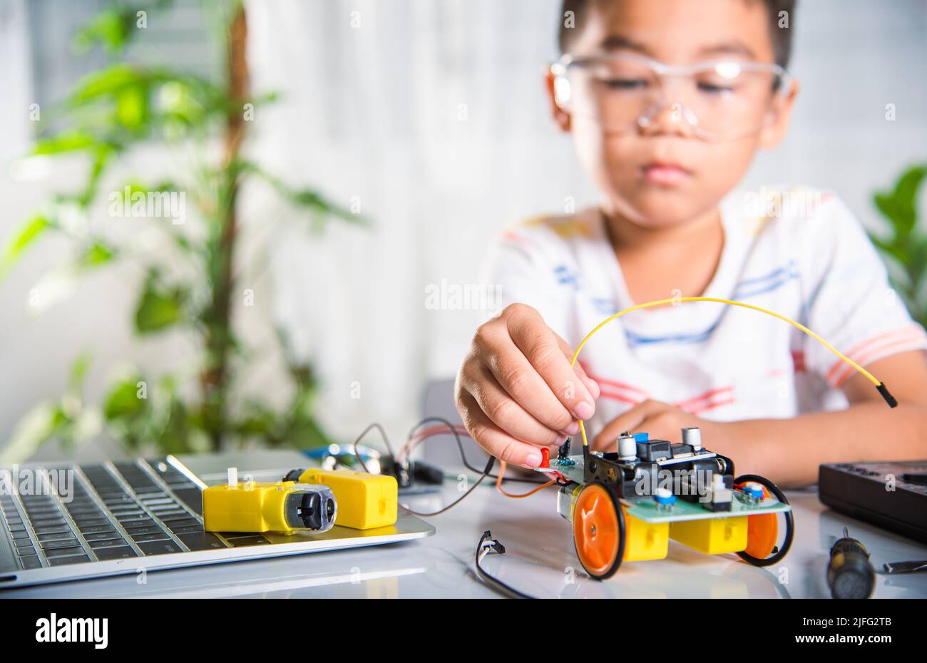 Little child remotely learn online with car toy before sent code, Asian ...