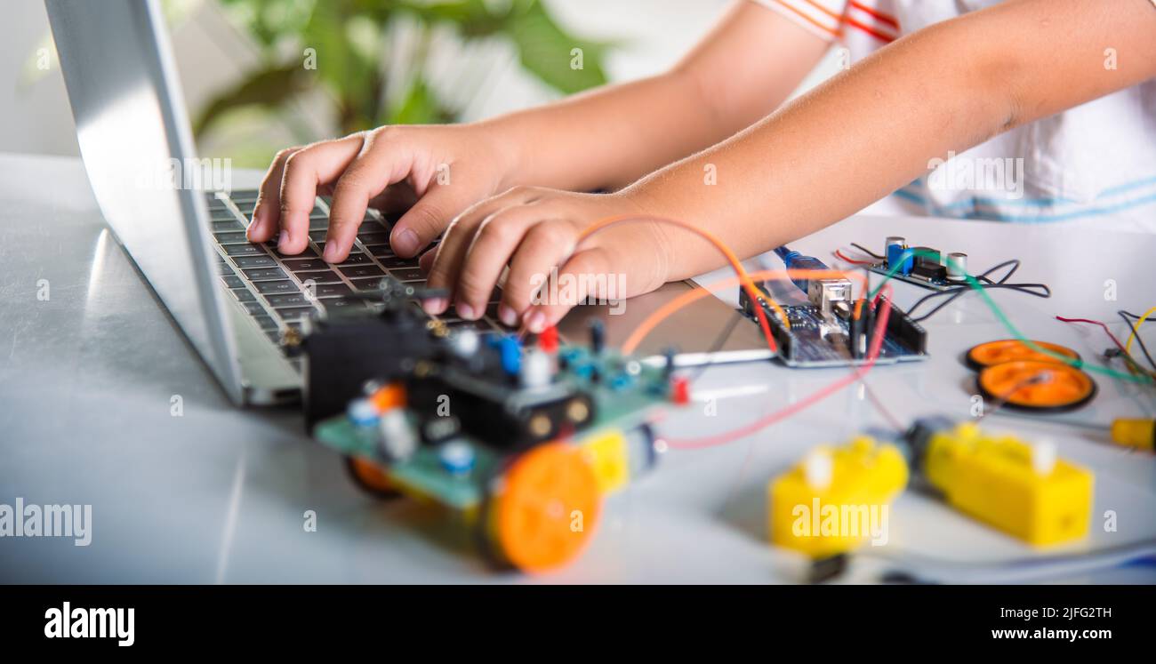 Asian kid boy learns coding and programming with laptop for Arduino ...
