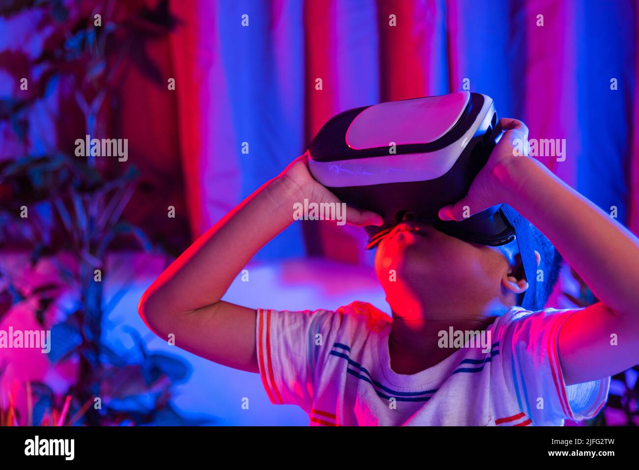 Little kid boy experiencing virtual reality goggles experiencing ...