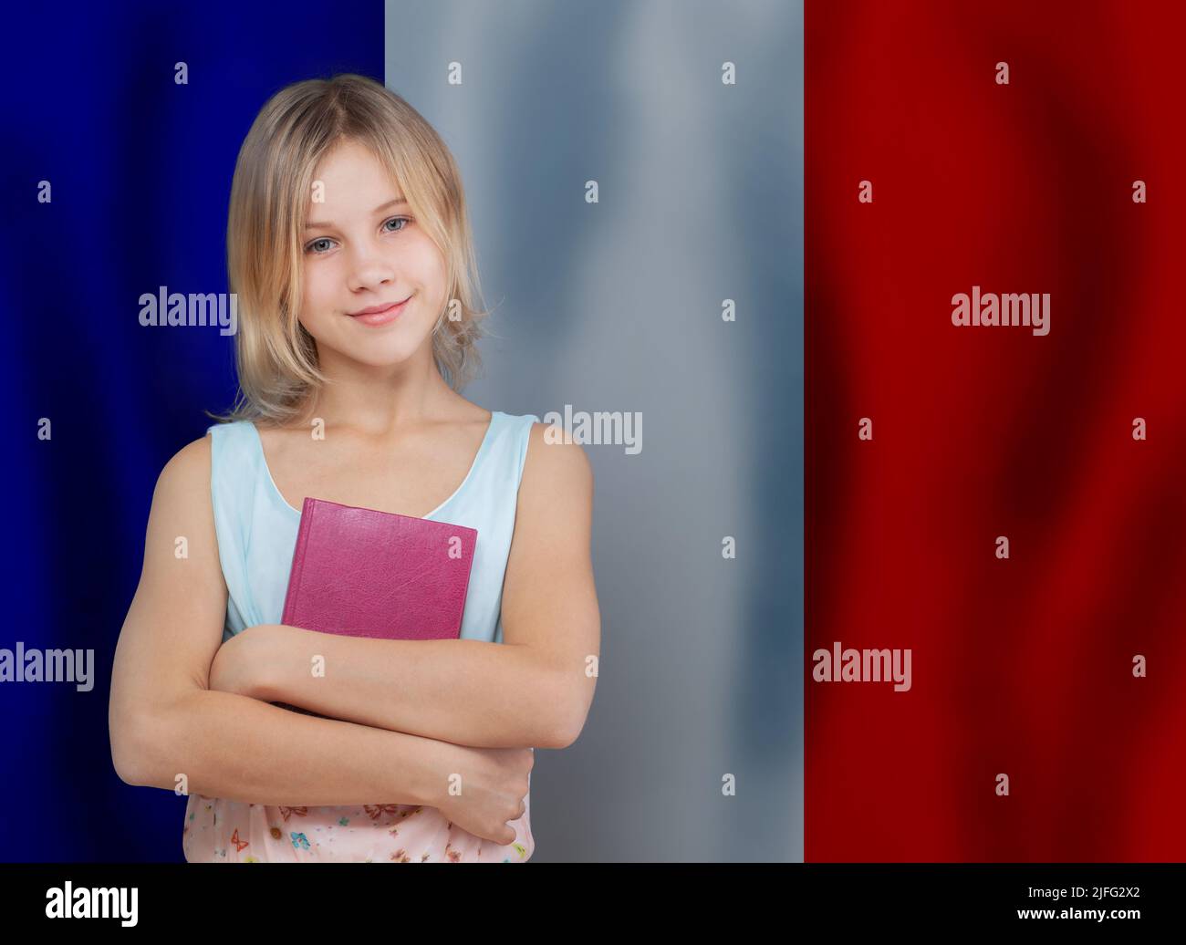 Beautiful cute little kid child girl with english book against France ...