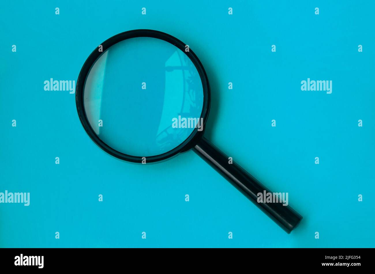 Blank magnifying glass on blue cover background. Copy space Stock Photo ...