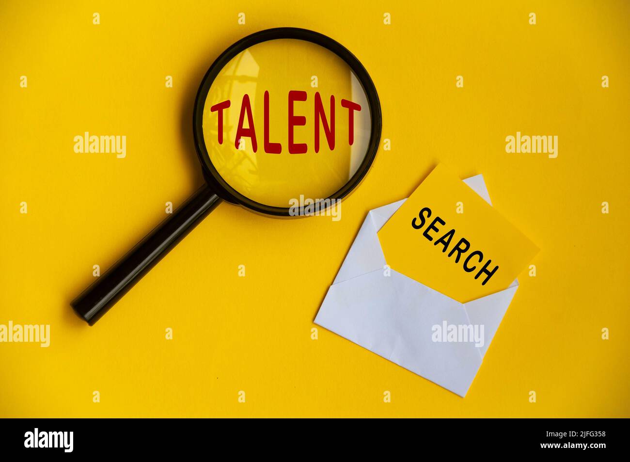 Talent search on magnifying glass and yellow notepad. Talent search ...