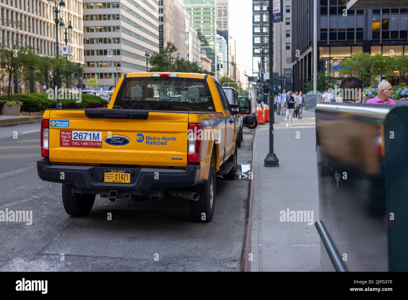 A yellow Metro-North Ford duty pickup car parked on a street in New ...