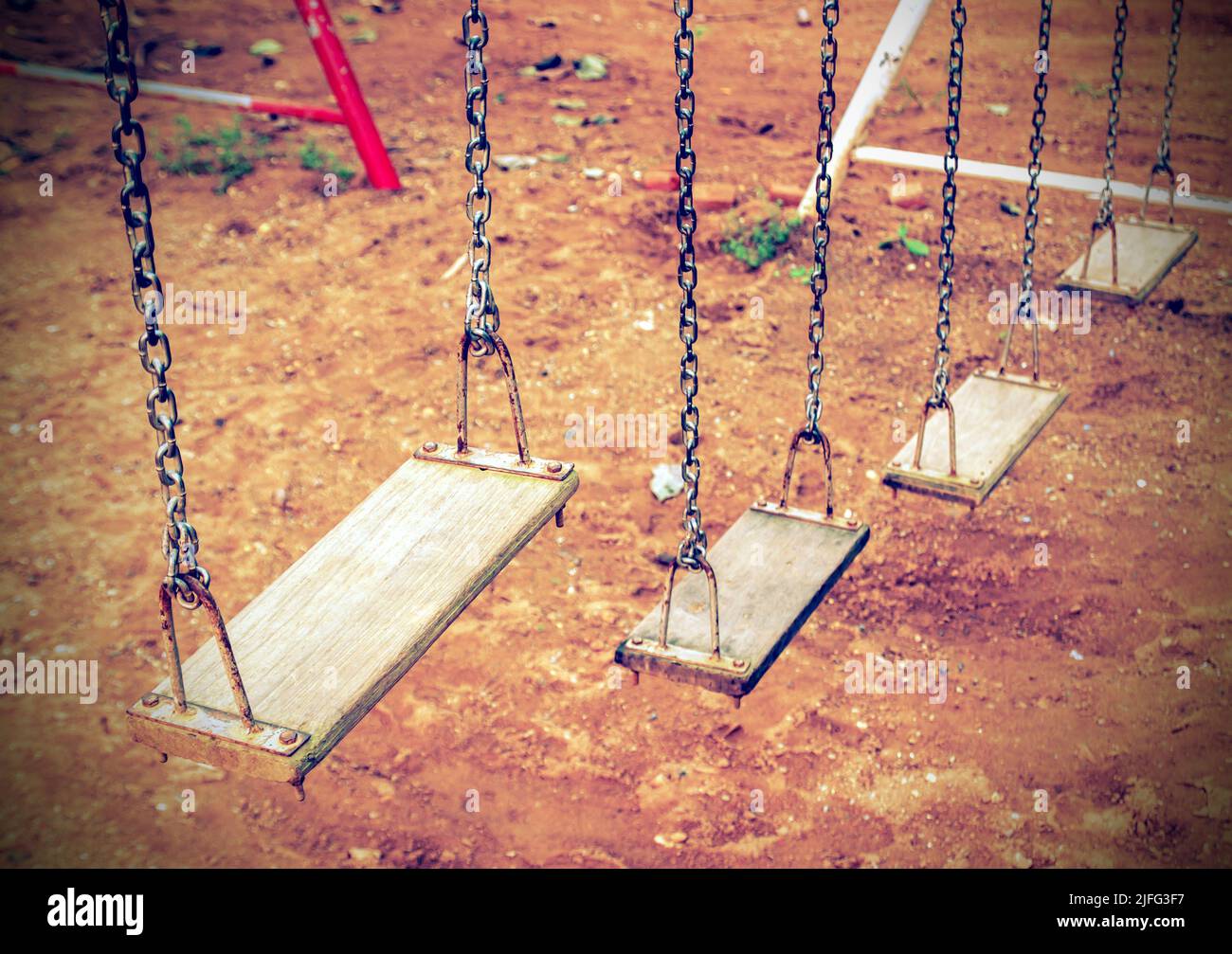 Empty chain swing in the playground. Vintage filter Stock Photo - Alamy