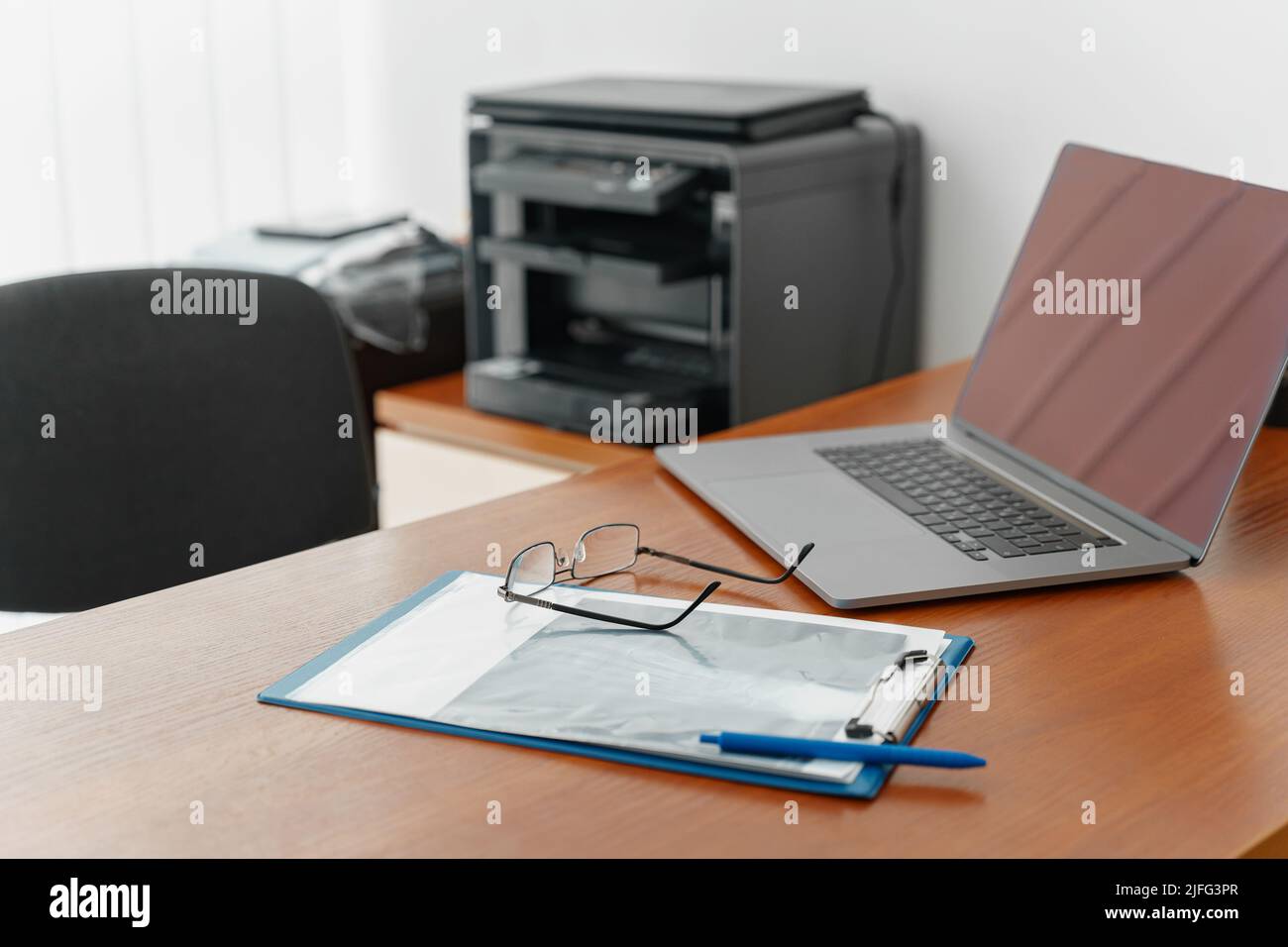 Working table of doctor therapist with laptop and medical documents ...