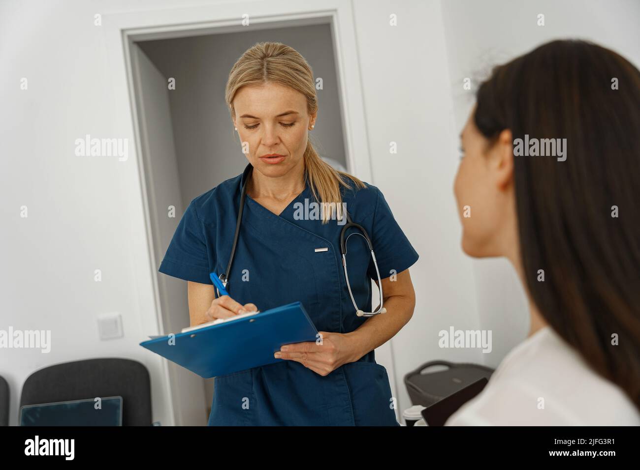 Doctor fills out the medical report form on medical care of patients ...