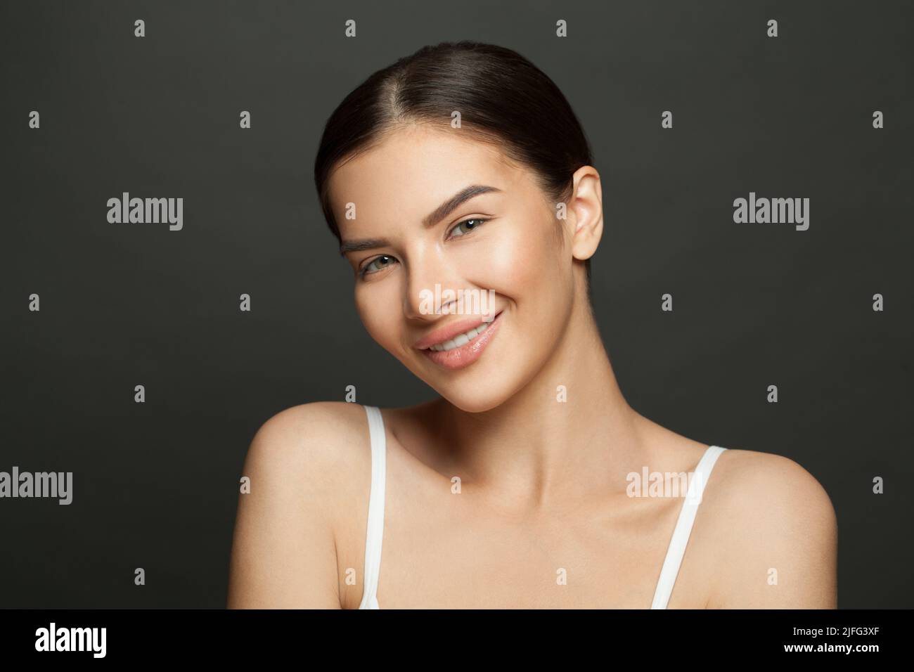 Young brunette model woman with clean skin, beautiful face close up ...