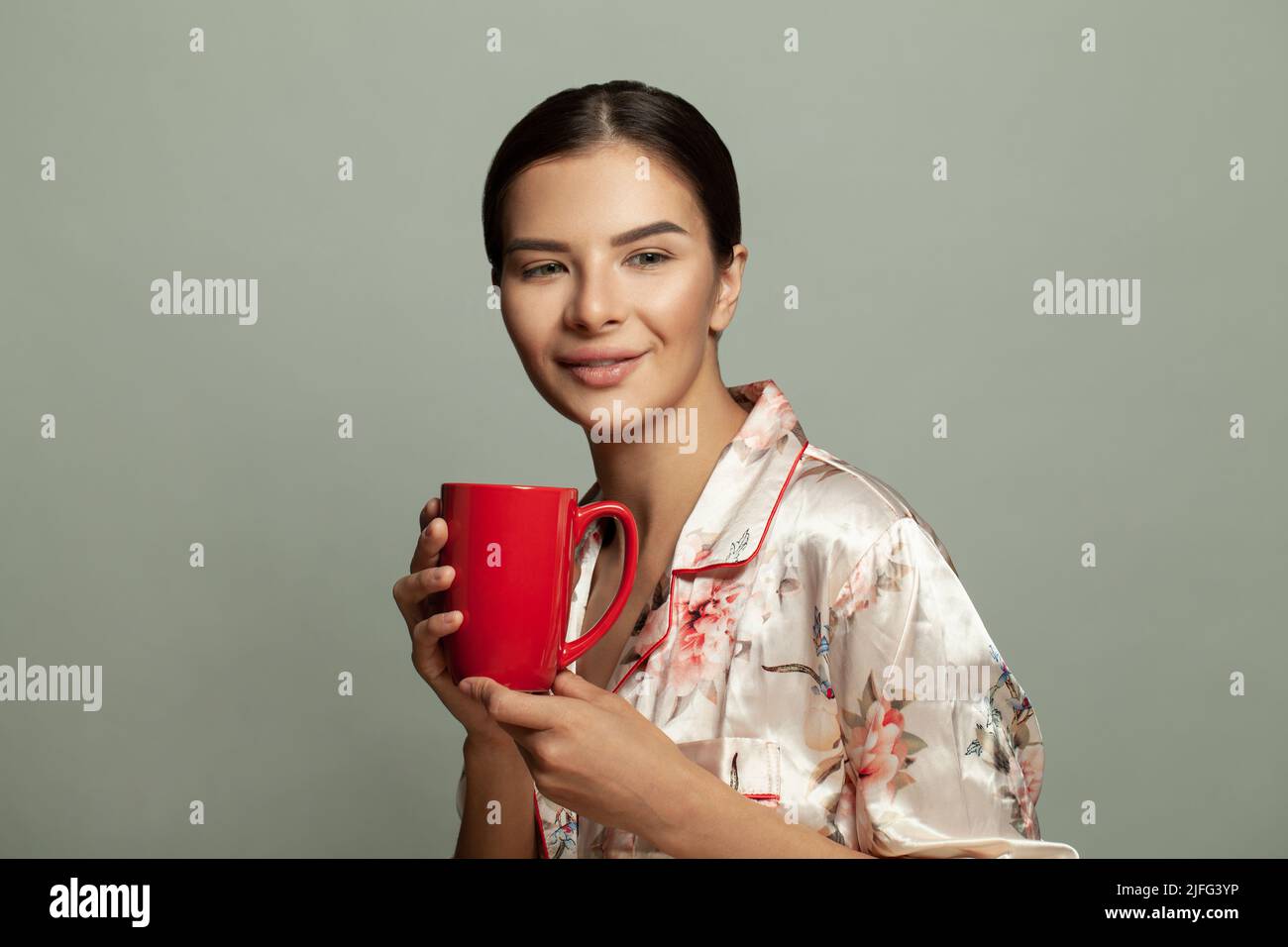 Beauty female model drinking coffee and smiling on white background ...