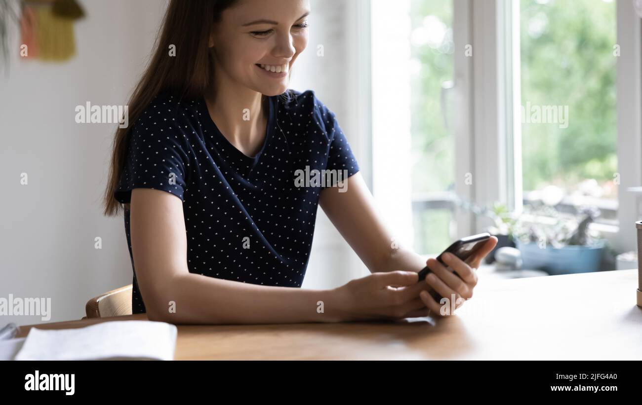 Cheerful adult gen Z mobile phone user girl texting message Stock Photo ...