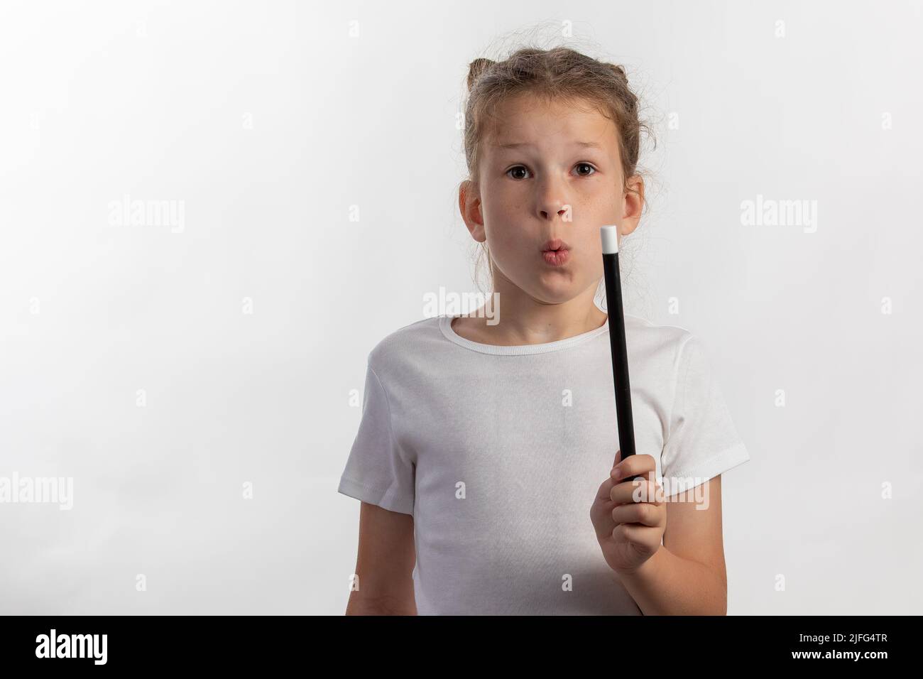 Girl magician - magic wand in child hands - young magician performing ...
