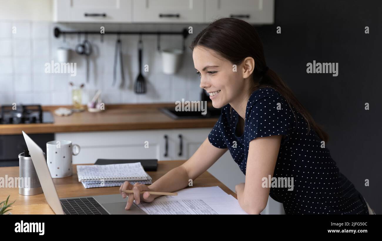 Happy busy freelance employee making video call on laptop Stock Photo ...