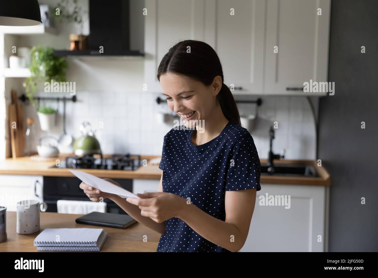 Cheerful happy student girl reading document, receiving letter from ...