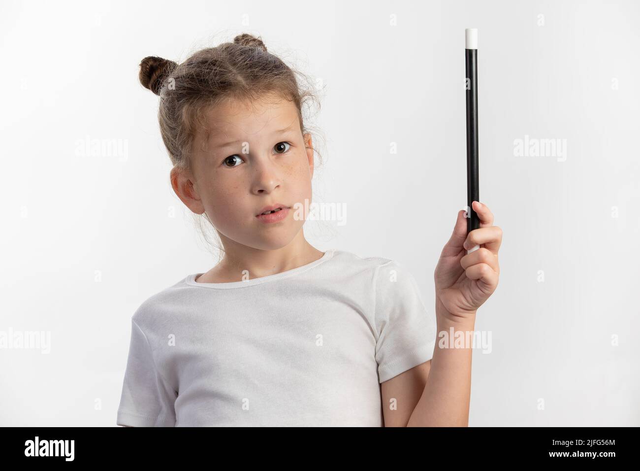 Girl magician - magic wand in child hands - young magician performing ...