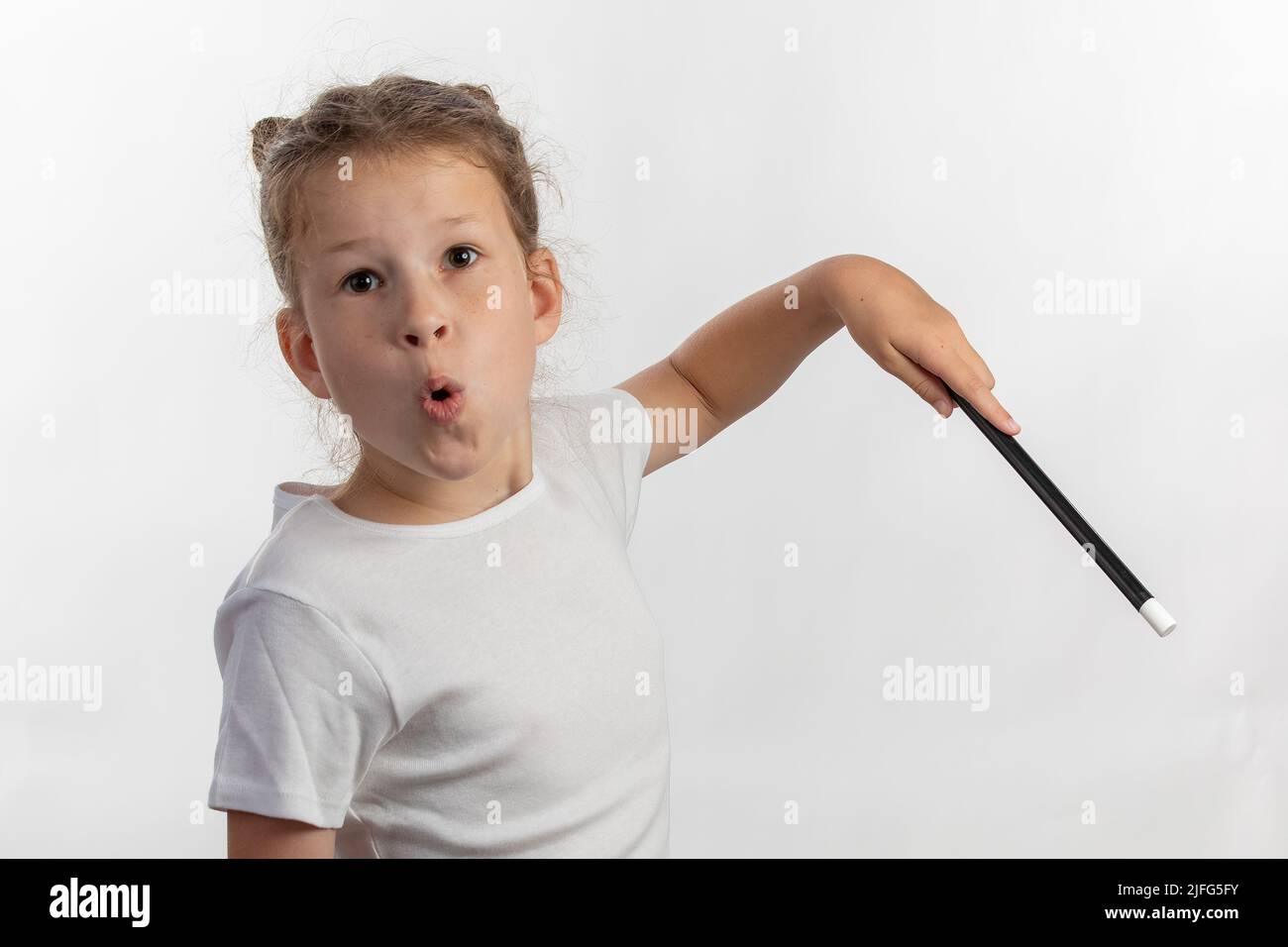 Girl magician - magic wand in child hands - young magician performing ...