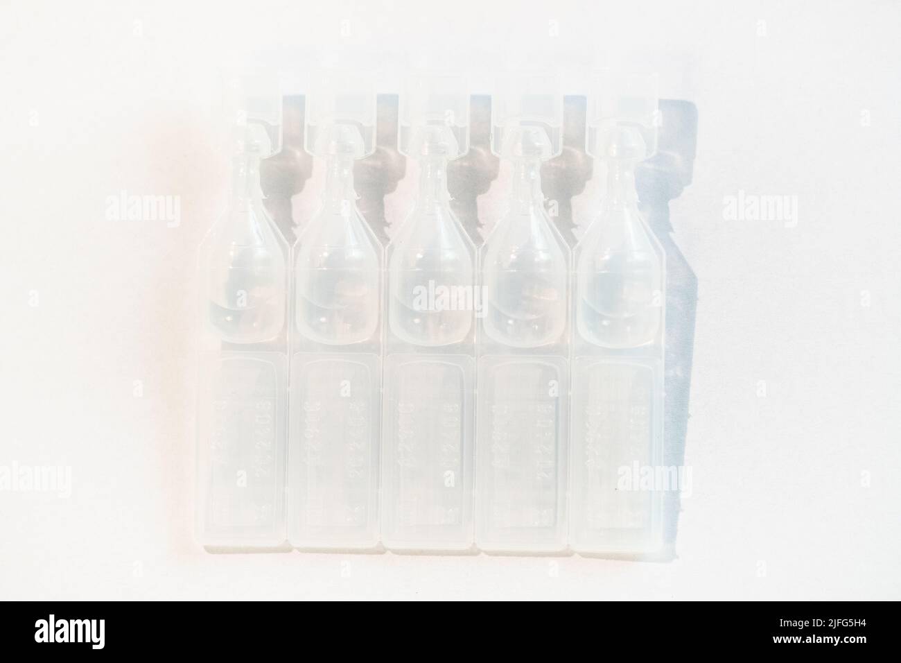 Photo of containers for eye drops on white background Stock Photo - Alamy