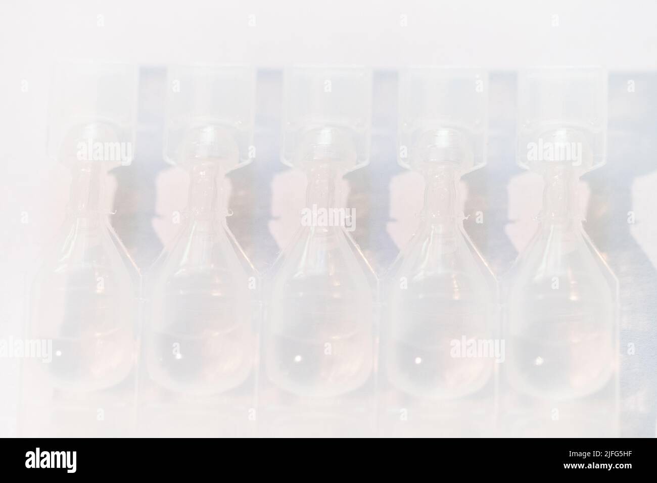 Photo of containers for eye drops on white background Stock Photo - Alamy