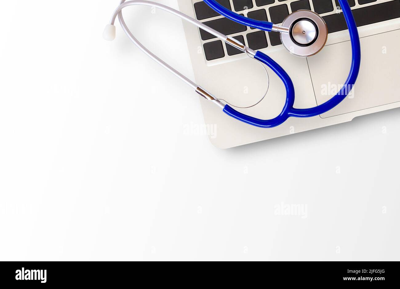 Medical stethoscope and laptop computer on white table background with ...