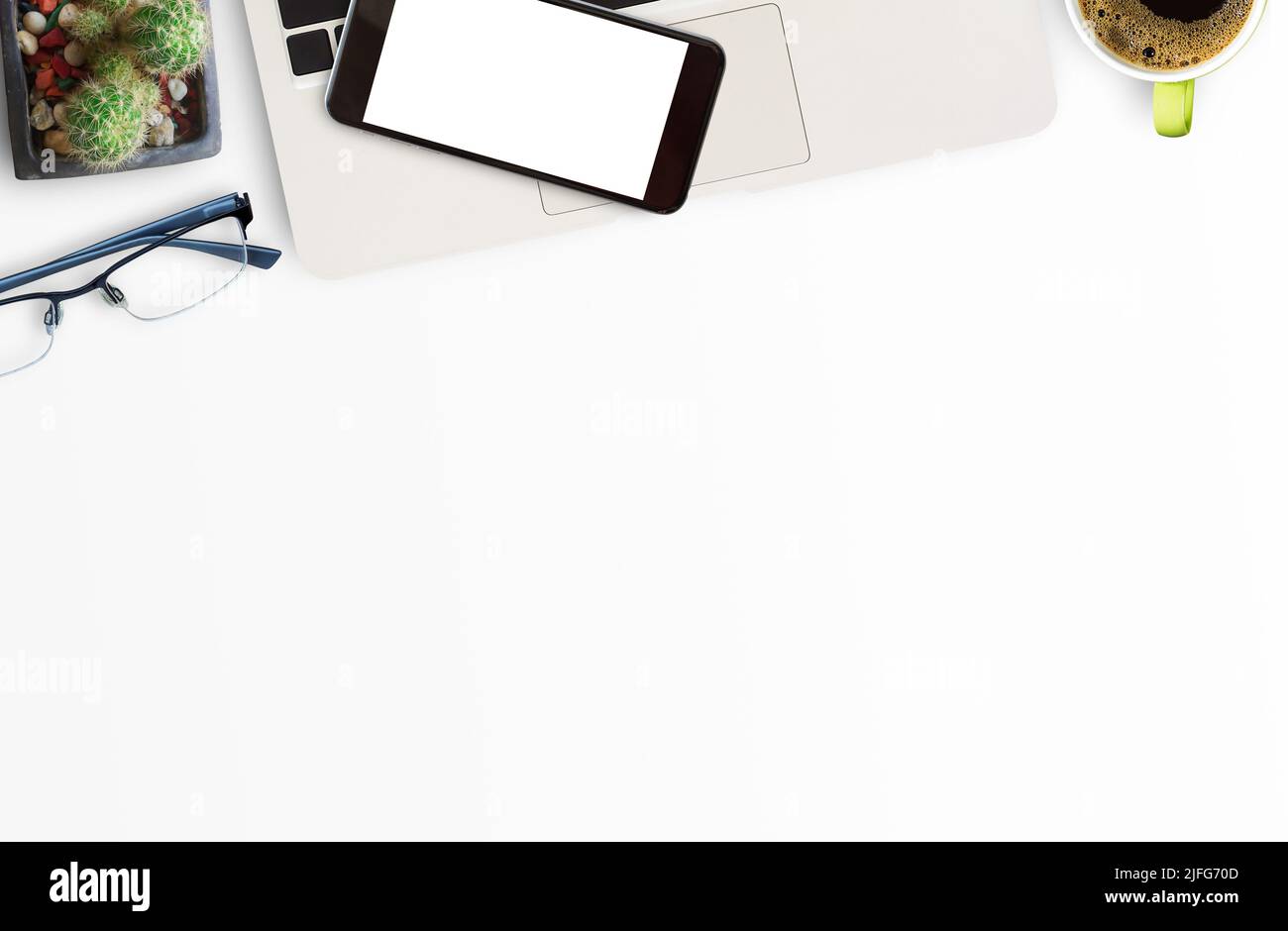 White office desk table with laptop computer, smartphone, and glasses ...