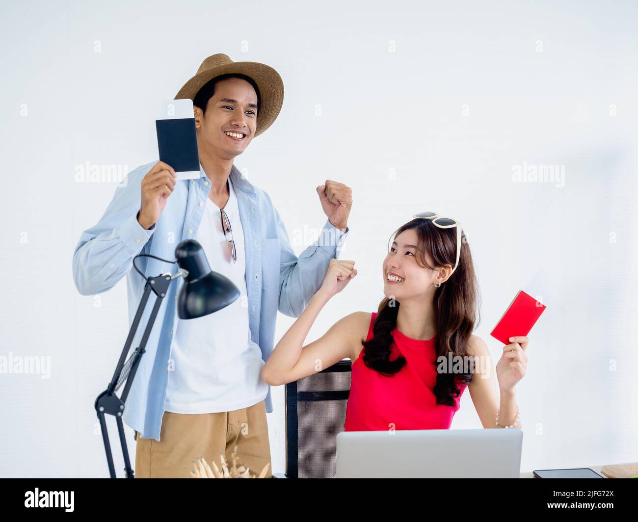 Happy Asian couple, young woman and man holding passport after using ...