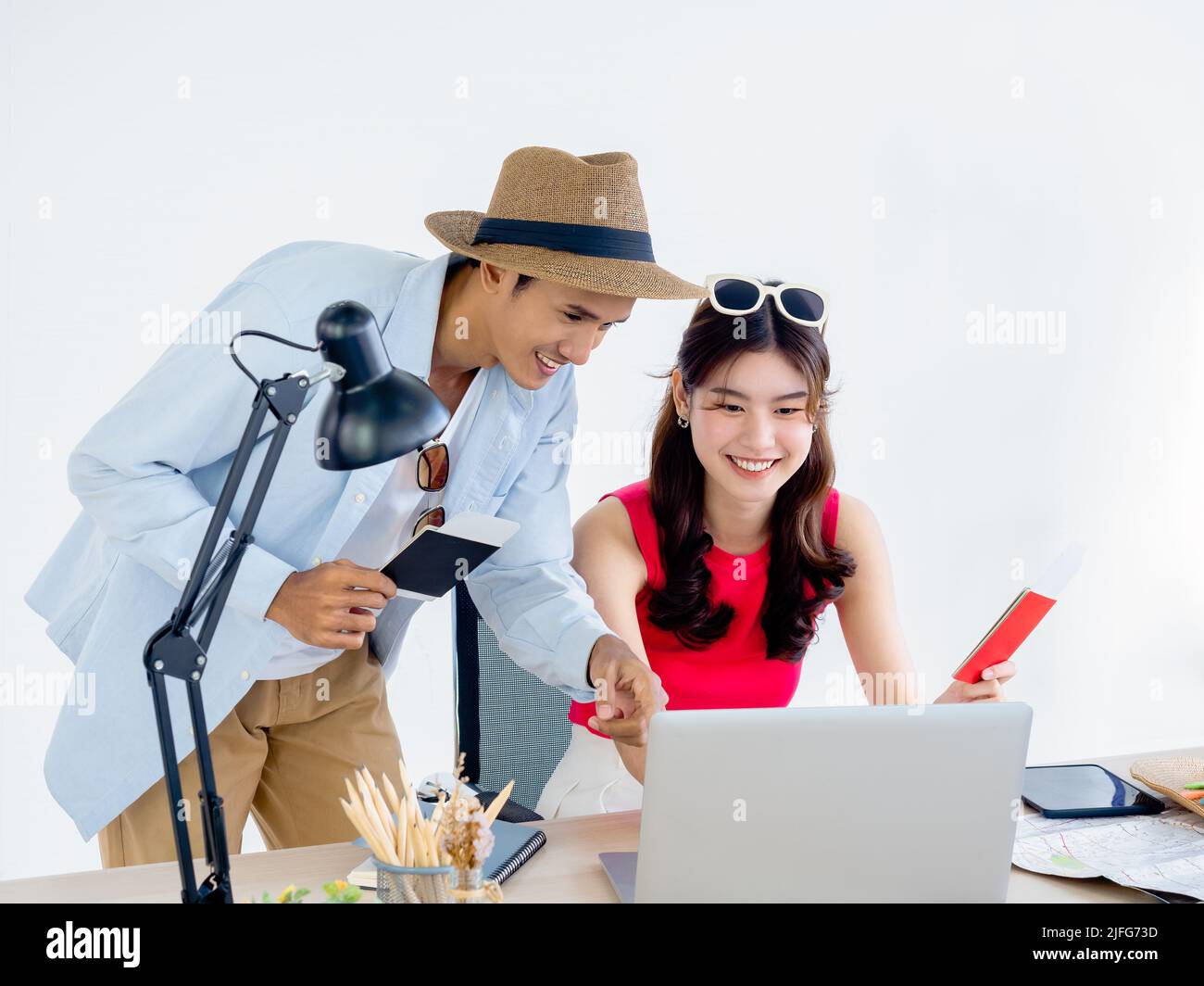 Happy Asian couple, young woman and man holding passport after using ...