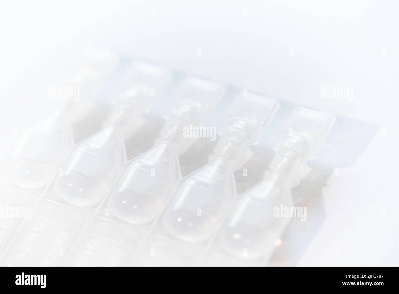 Photo of containers for eye drops on white background Stock Photo - Alamy