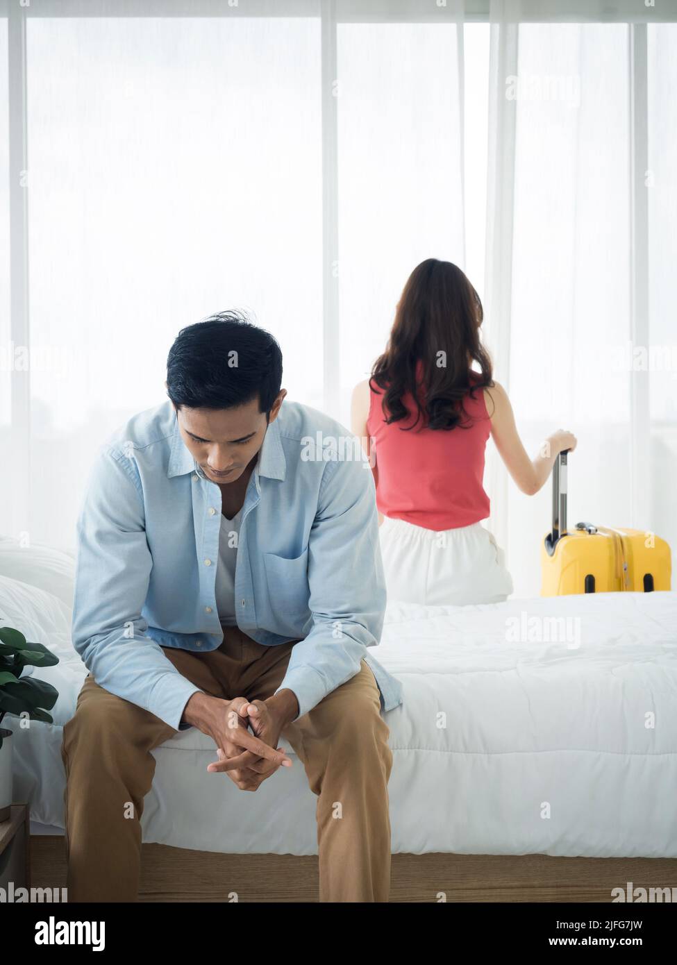 The anxiety of Asian couple lovers on the bed. Stressed man and young ...