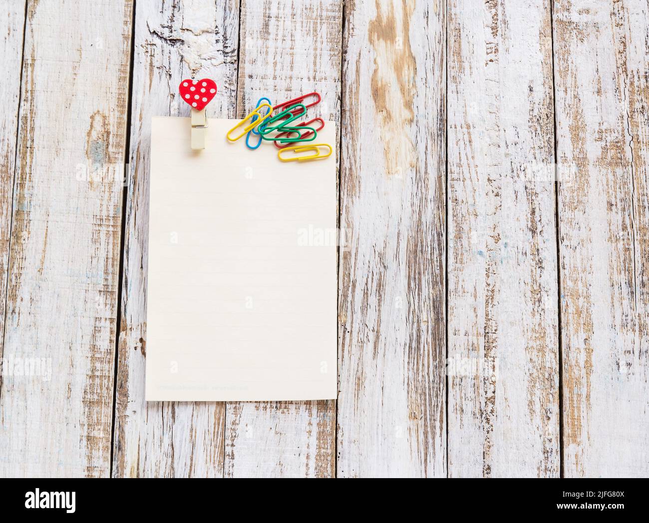 Paper and paperclip on white wooden table background Stock Photo - Alamy
