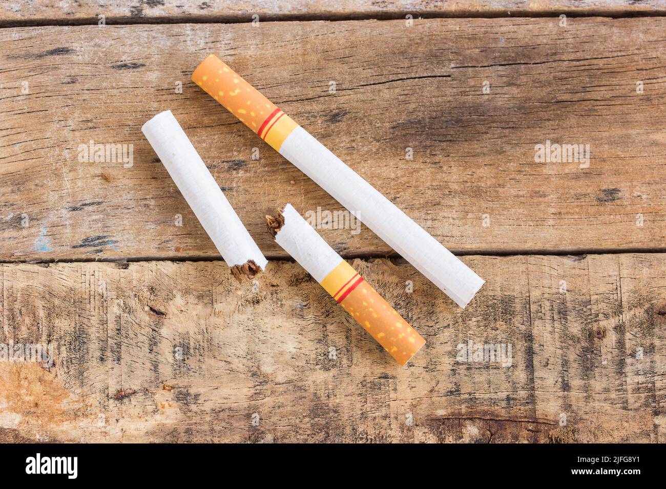 Cigarette roll on old wooden table background Stock Photo - Alamy