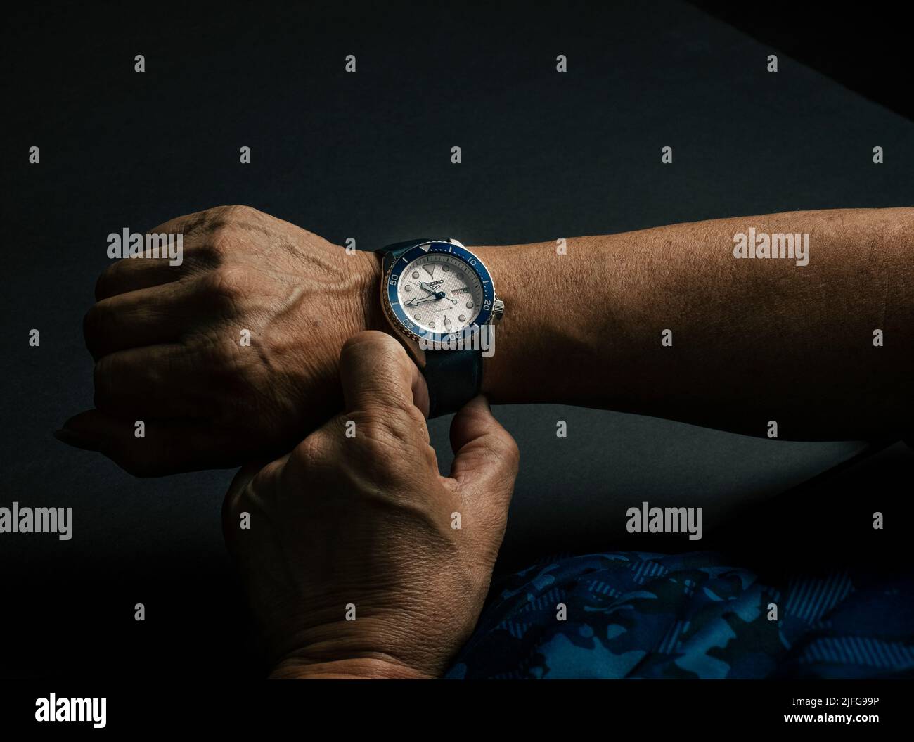 Asian Man with brown skin wearing blue diver Seiko watch Stock Photo ...