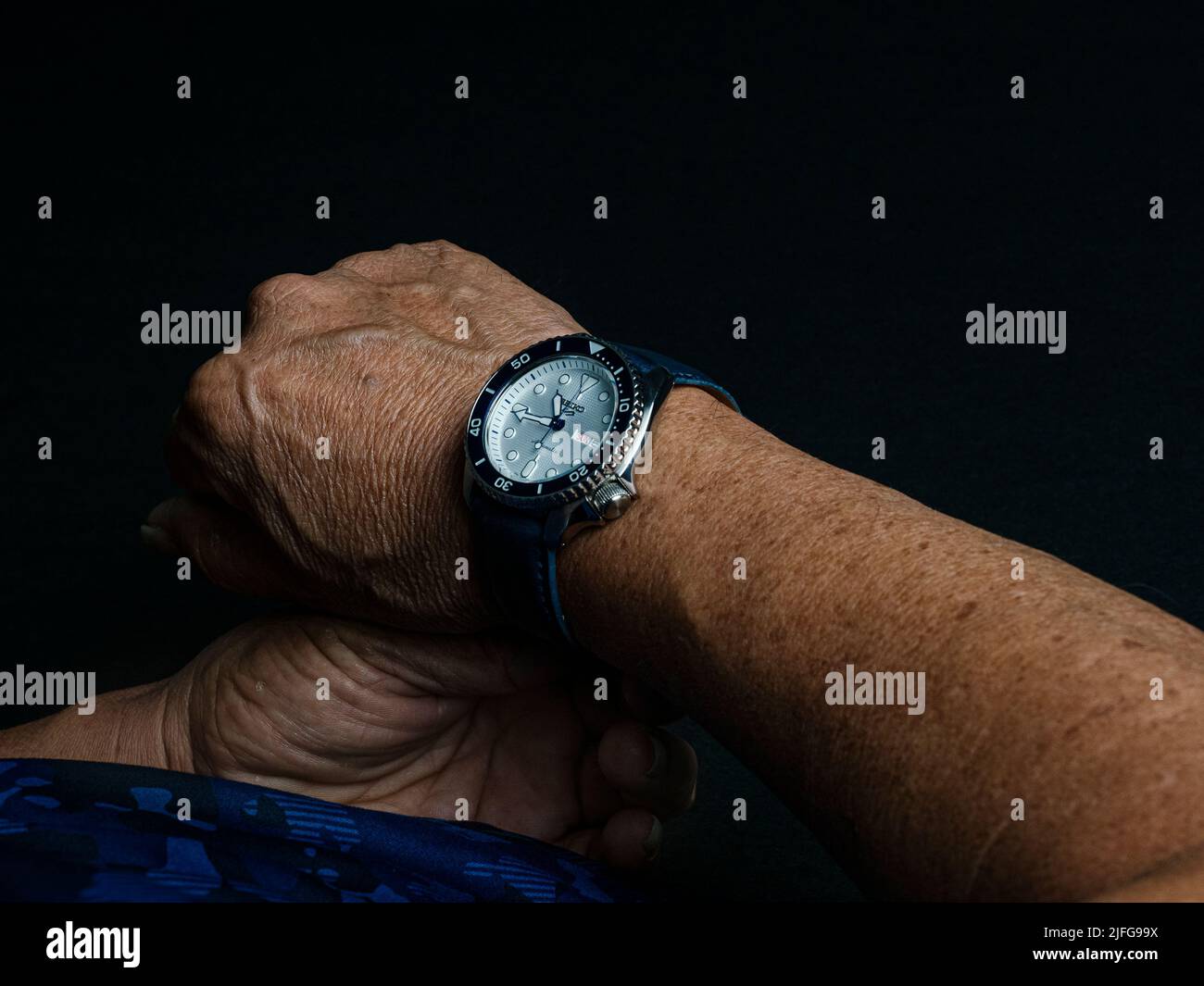 Asian Man with brown skin wearing blue diver Seiko watch Stock Photo ...