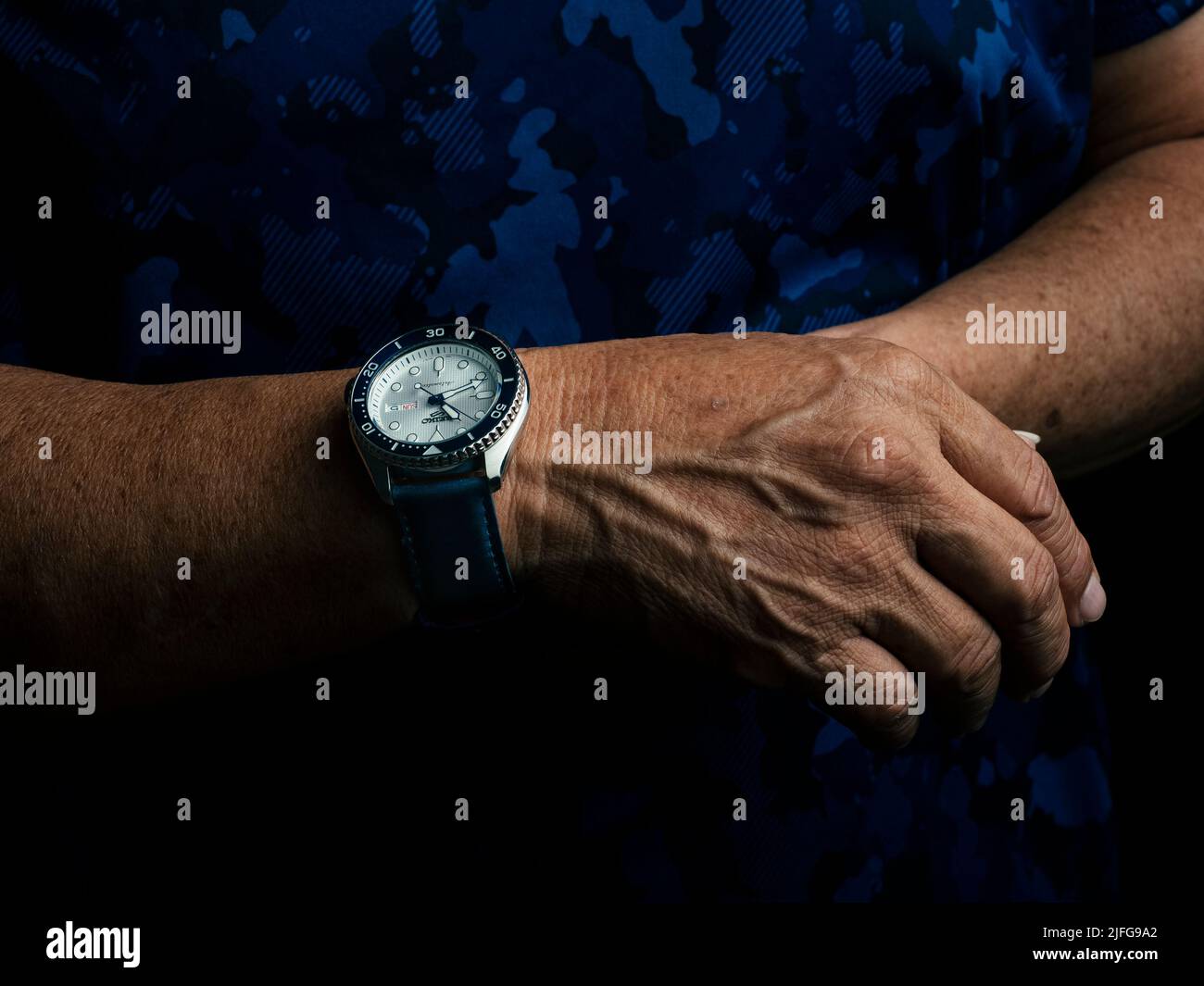 Asian Man with brown skin wearing blue diver Seiko watch Stock Photo ...