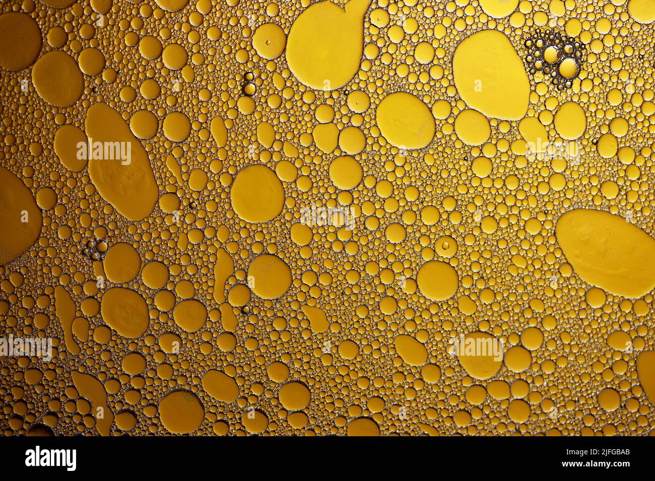 Yellow oil drops on the water surface Stock Photo - Alamy