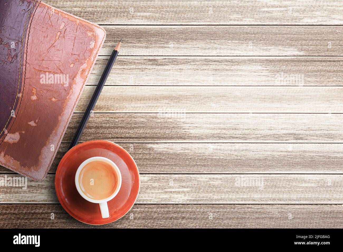 Office desk table with notebook,pencil and coffee cup.Top view with ...